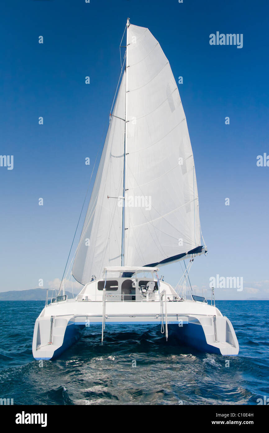 Luxury white catamaran boat in the ocean with blue sky Stock Photo - Alamy