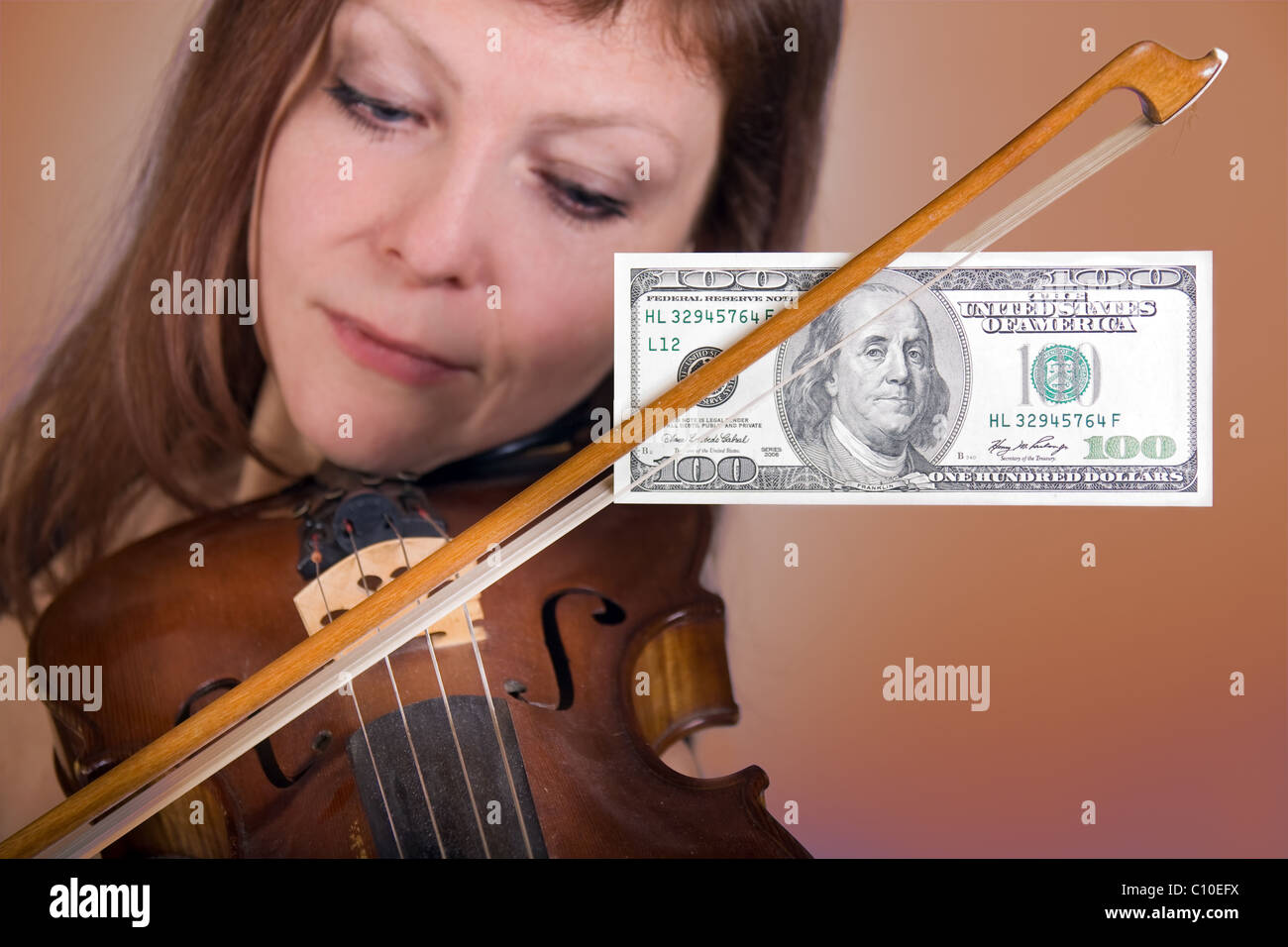 woman plays the viola with banknotes Stock Photo - Alamy