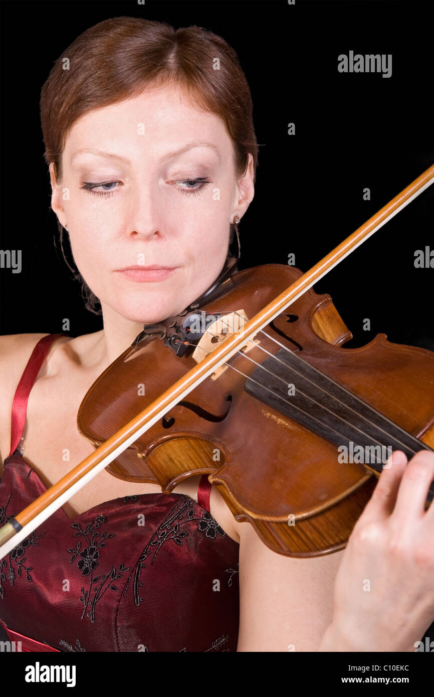 young woman plays the viola on black background Stock Photo - Alamy