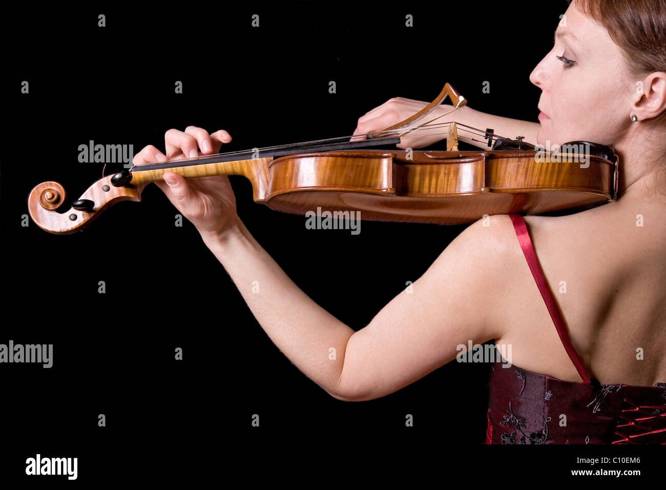 young woman plays the viola on black background Stock Photo - Alamy