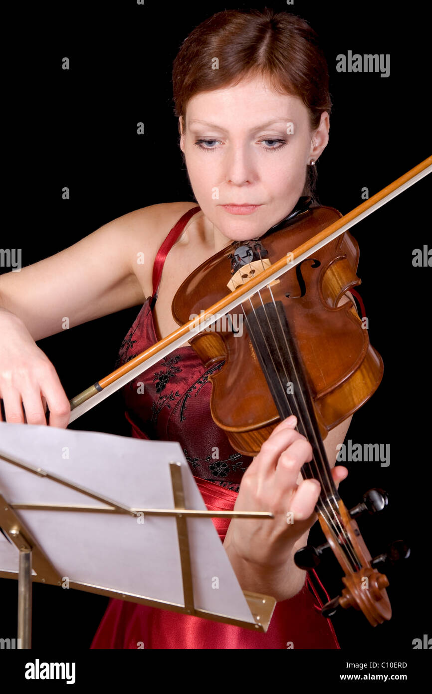 young woman plays the viola on black background Stock Photo - Alamy
