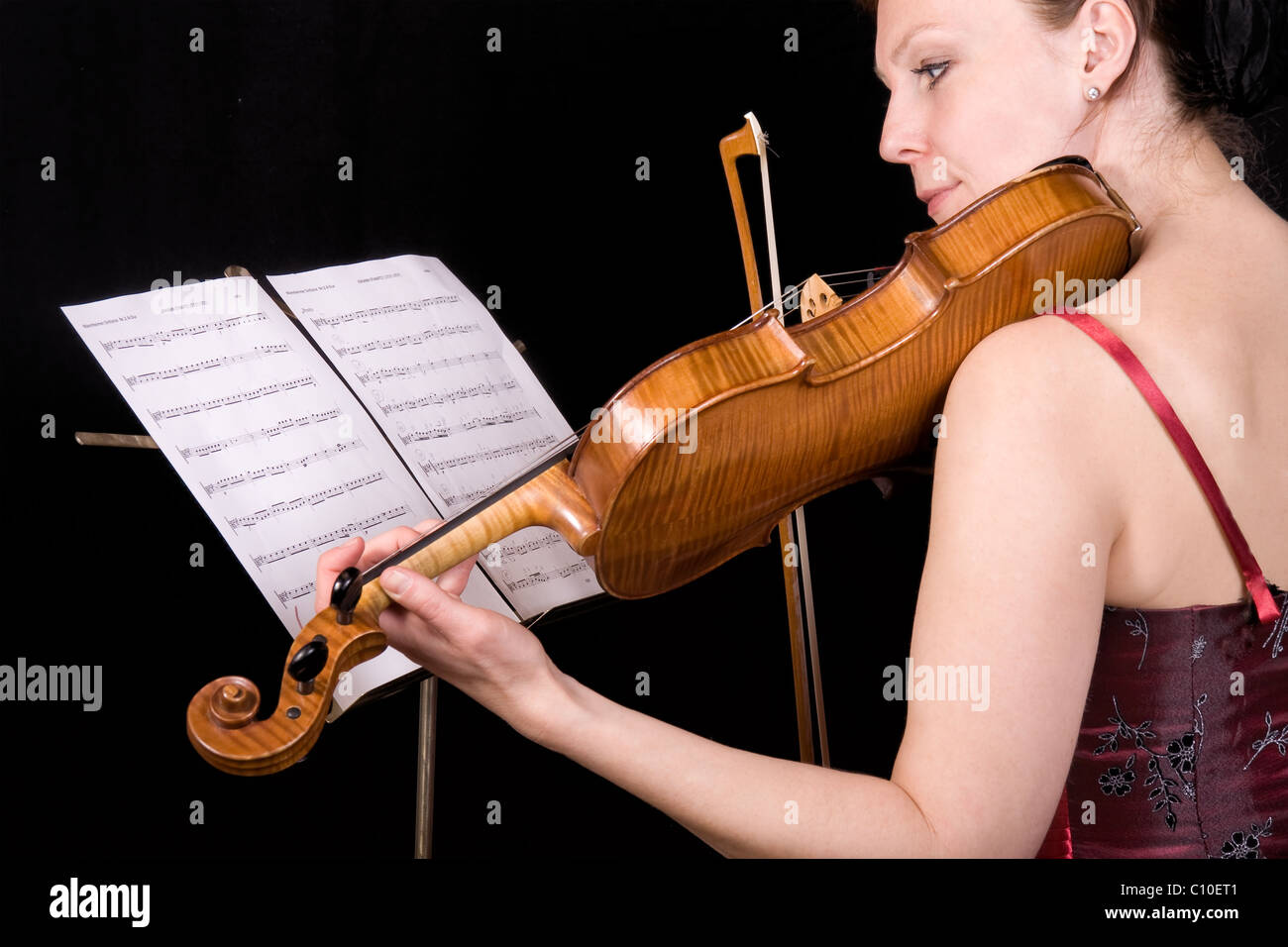 young woman plays the viola on black background Stock Photo - Alamy