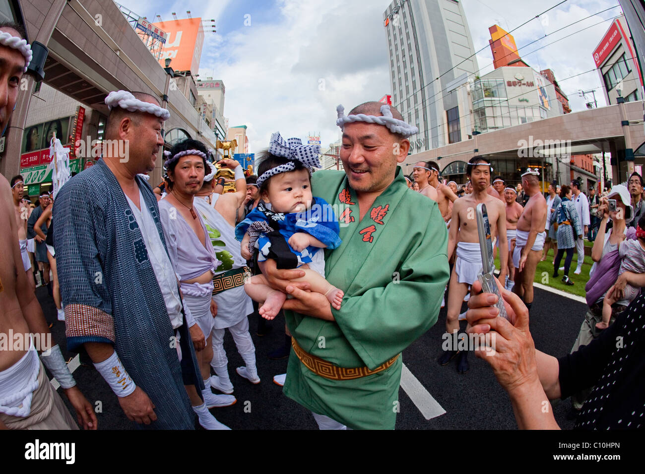 KAGOSHIMA CITY, JAPAN -July 19. Japanese man holding his baby at the ...