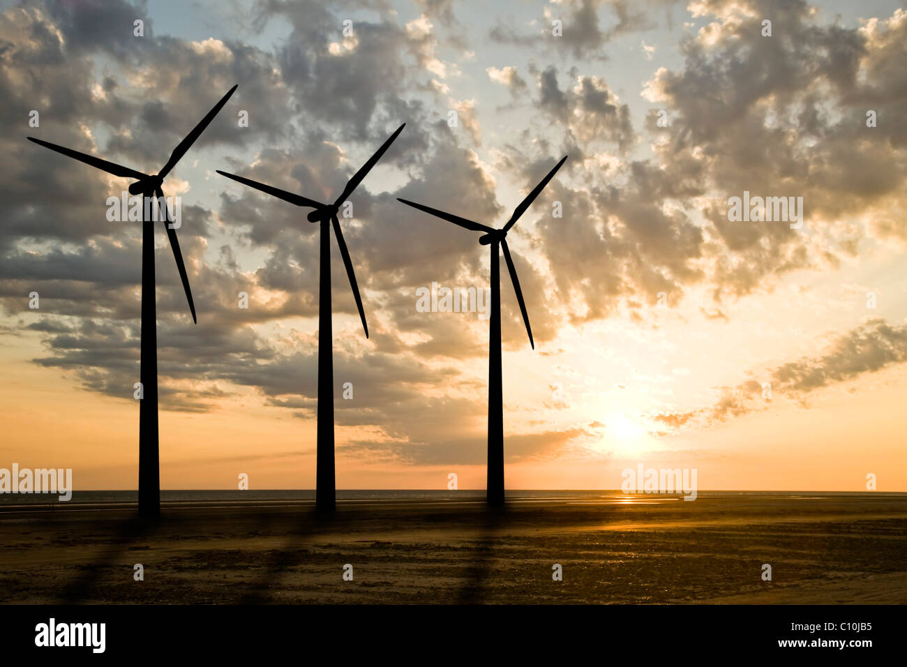 Silhouette of three windturbines in sunset Stock Photo - Alamy