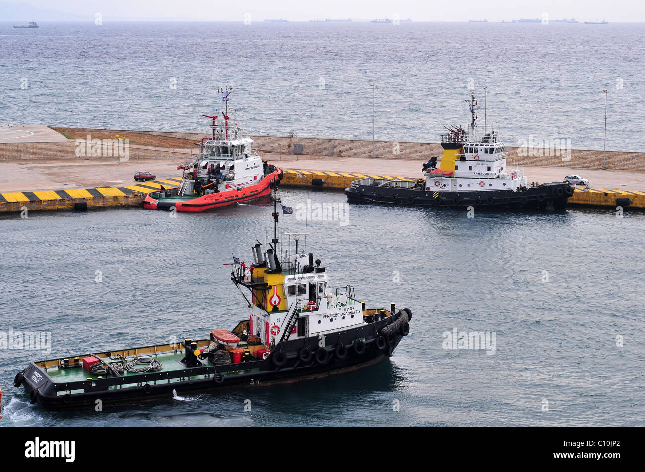 Three tugs waiting near the harbour breakwater at Pireas, Athens ...