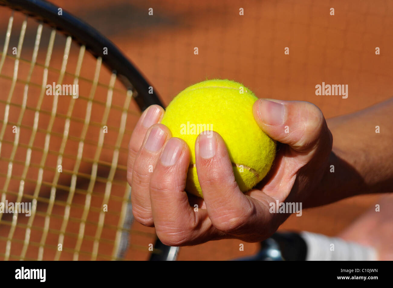 Player's hand with tennis ball preparing to serve Stock Photo - Alamy