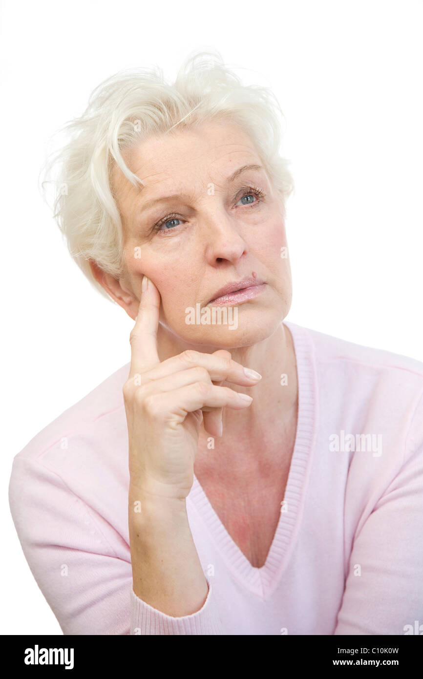 A mature woman looking thoughtfully into the distance Stock Photo - Alamy