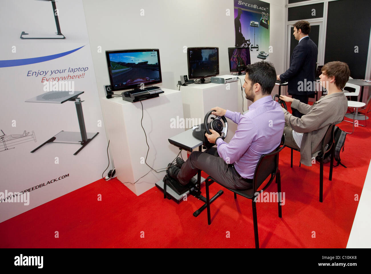 Visitors driving a race car in a video game, Internationale ...