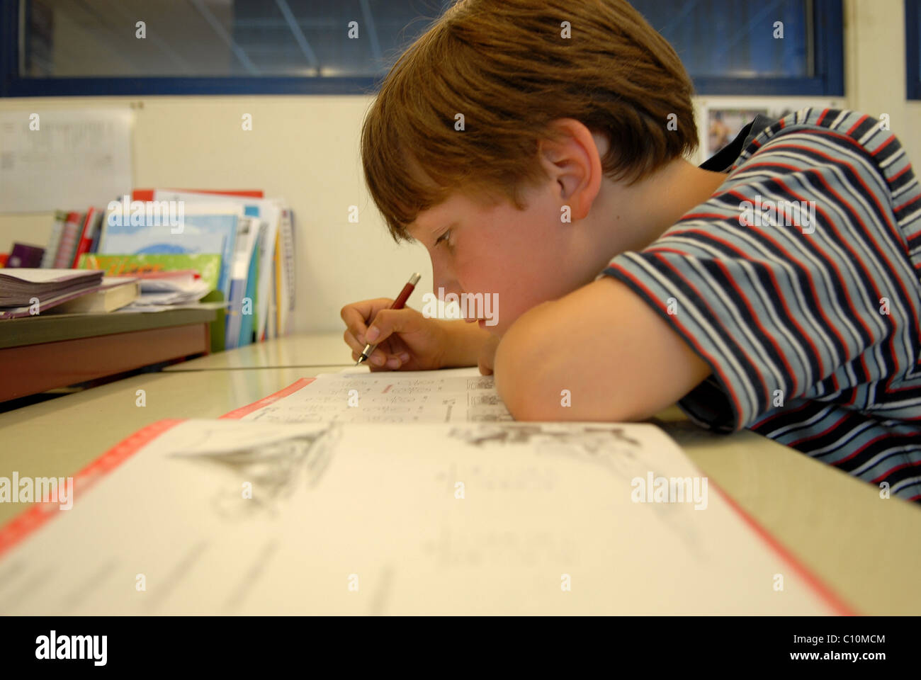 Boy studying in classroom Stock Photo - Alamy