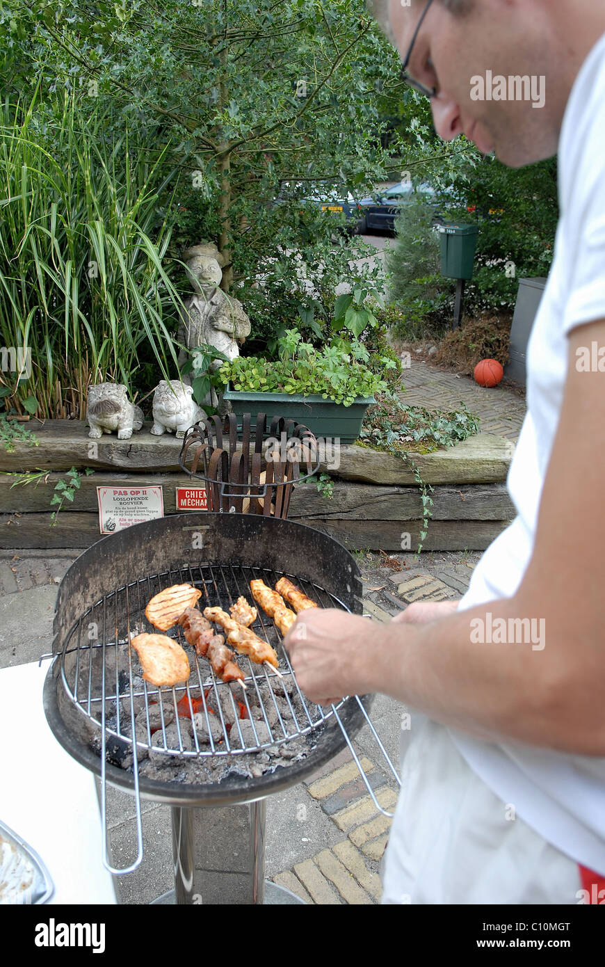Man cooking barbeque Stock Photo - Alamy