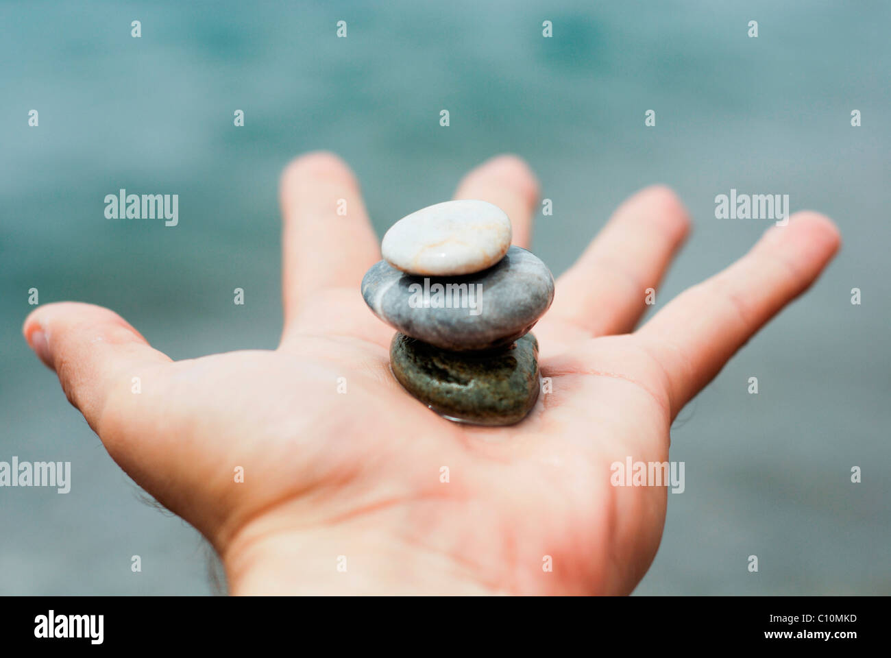 Hand holding pebbles Stock Photo - Alamy