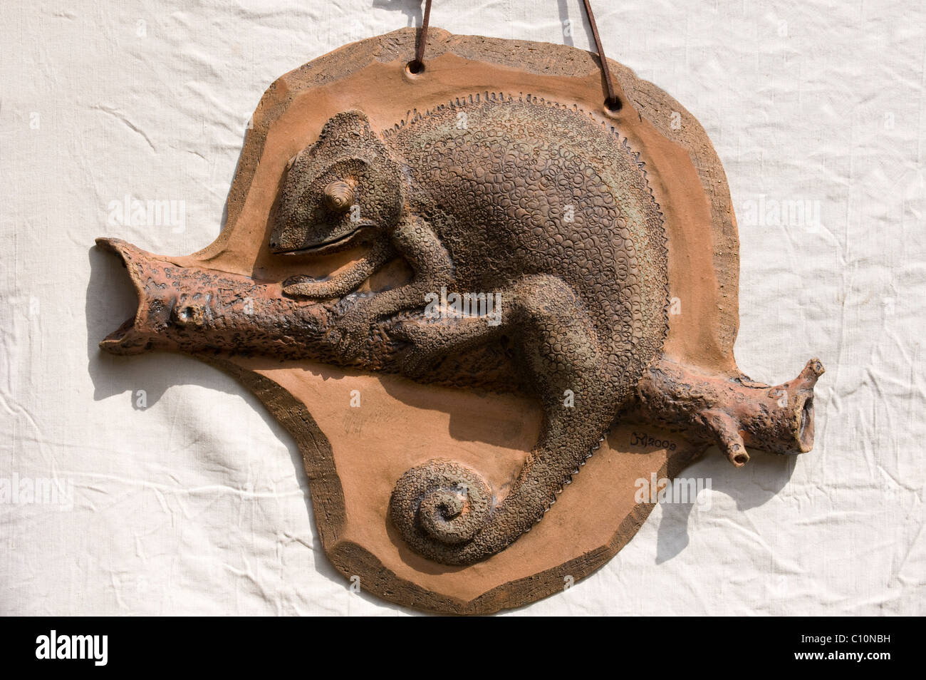 Clay chameleon, relief Stock Photo - Alamy