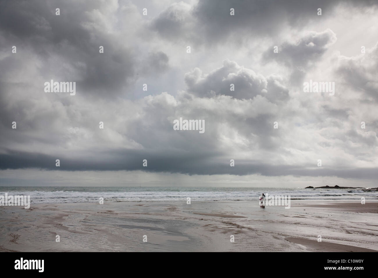 Wintry seaside scene with people walking on the beach in South Devon ...