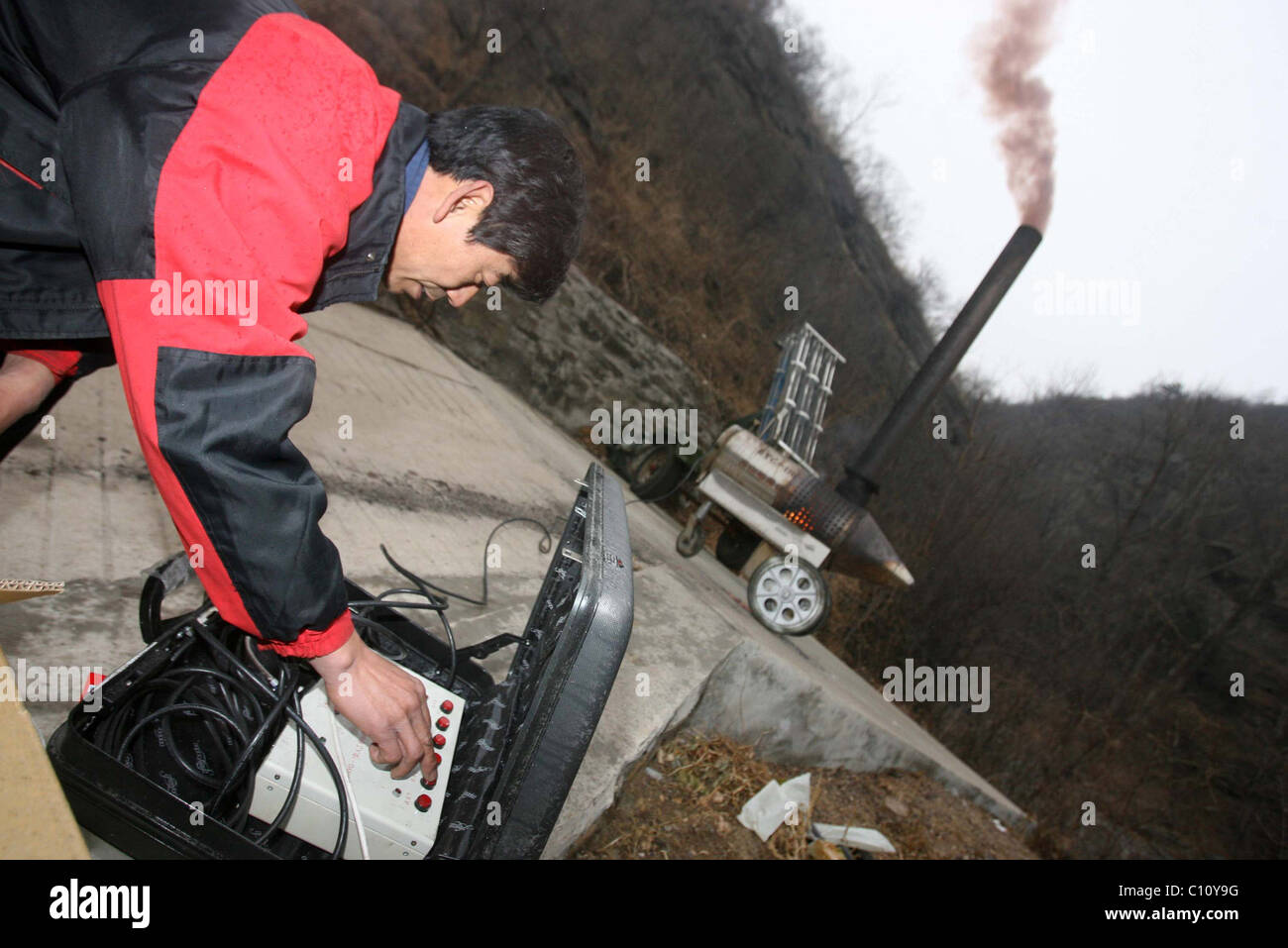 Rainmaker Workers in China release chemicals into the atmosphere in a ...