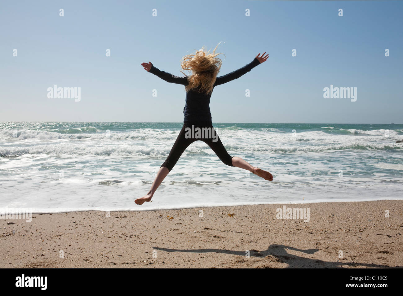 Exuberant child at edge of the sea Stock Photo - Alamy