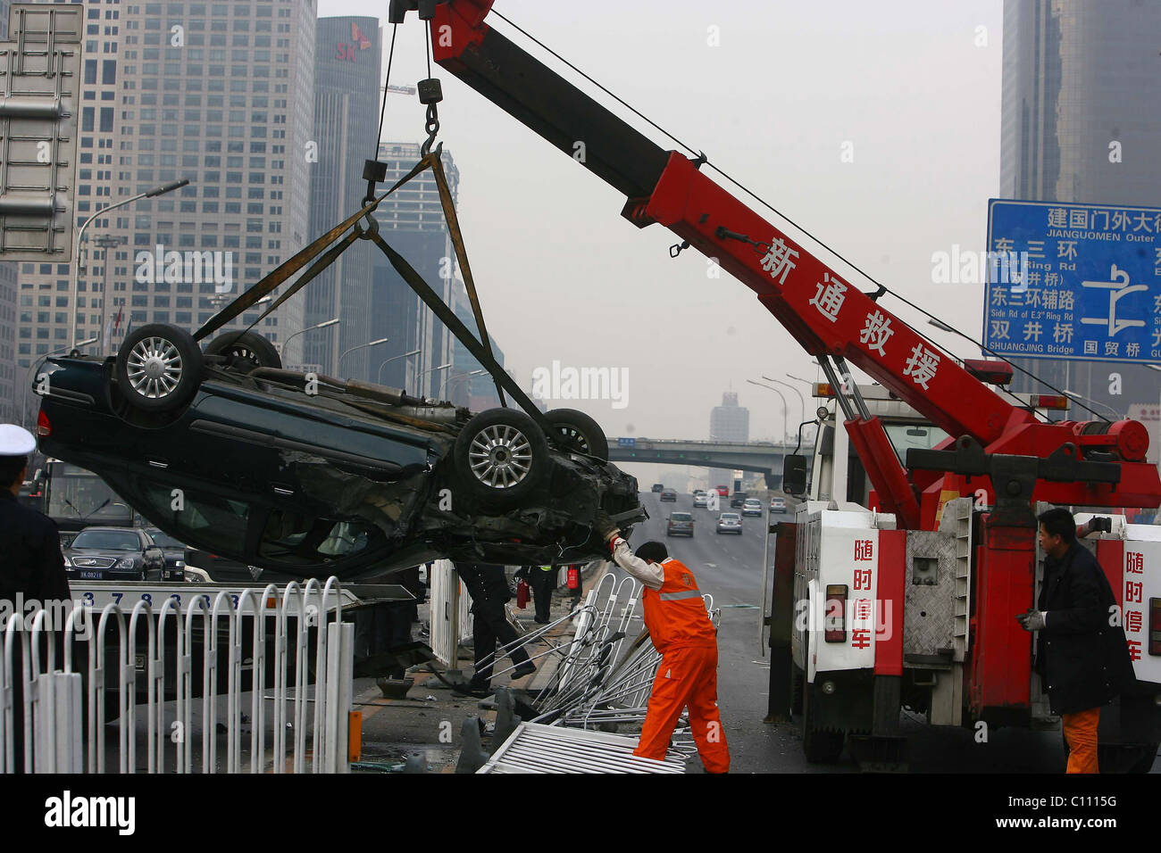 Beijing Smash Recovery crews remove the wreckage of a horrific car ...
