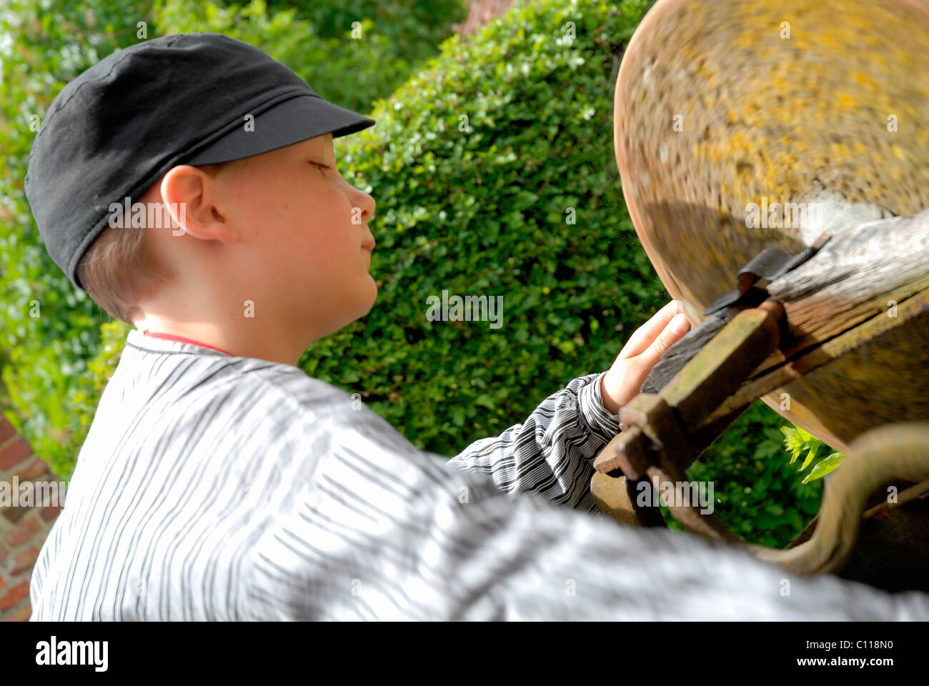 Young boy labour working outdoors Stock Photo - Alamy