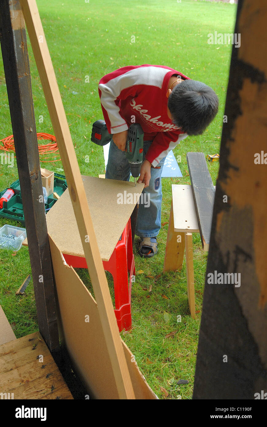 Young boy constructing woodwork Stock Photo - Alamy