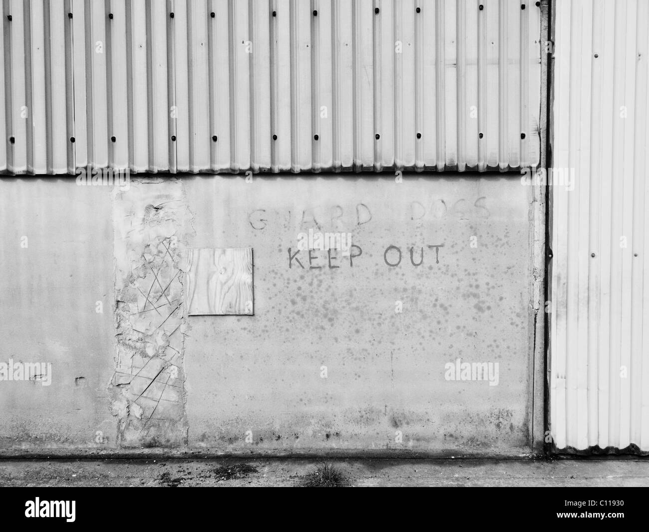 'Guard Dogs Keep Out' sign on side of farm shed building Stock Photo ...