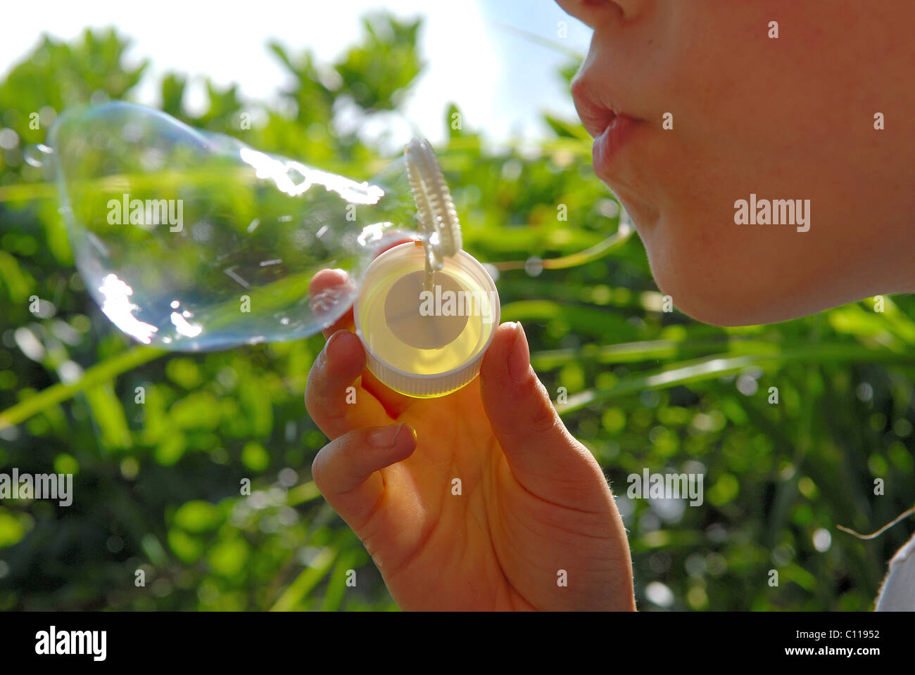 Close-up of boy blowing bubbles Stock Photo - Alamy