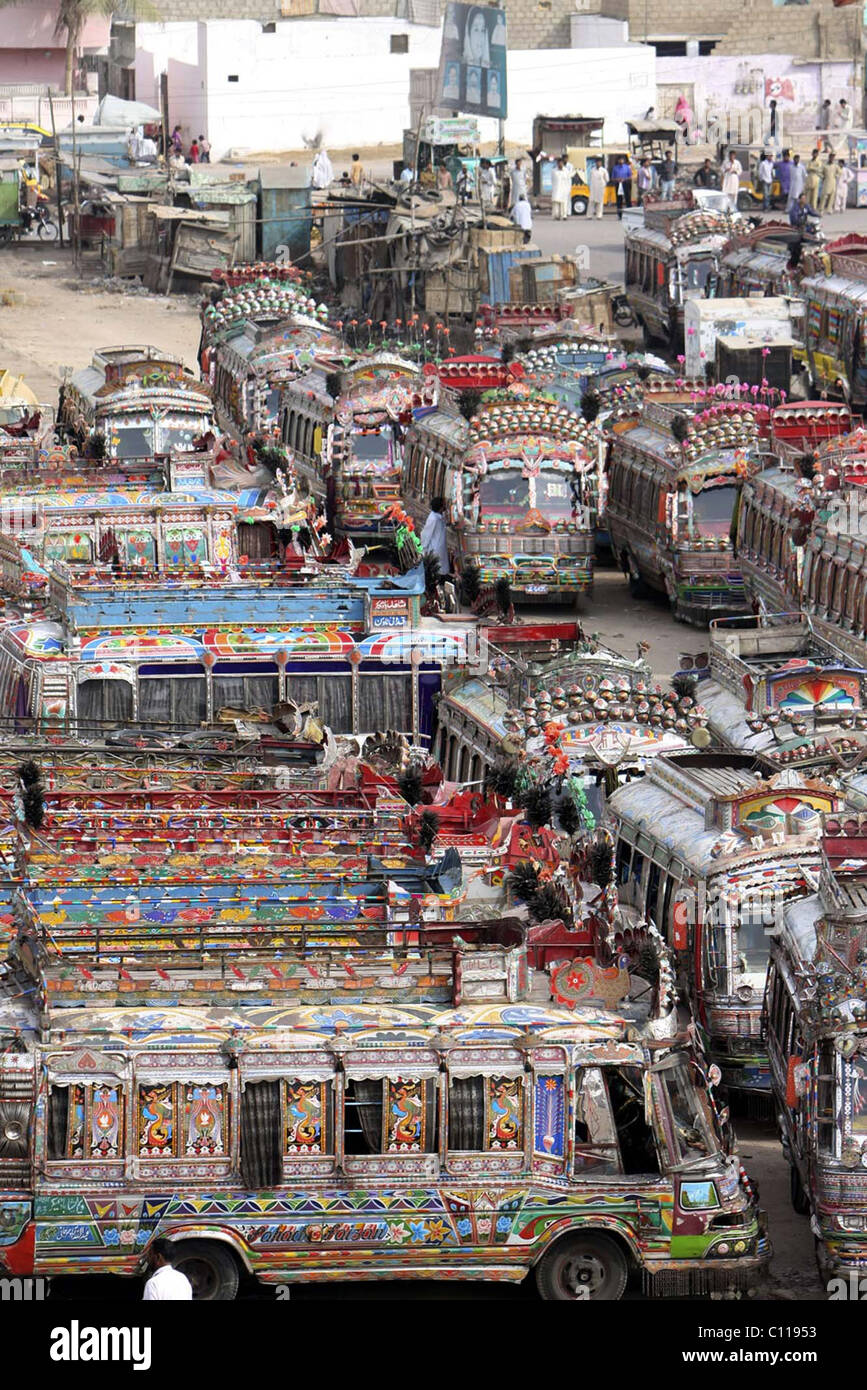 Passengers vehicles are seen parked at a bus stand as transporters ...