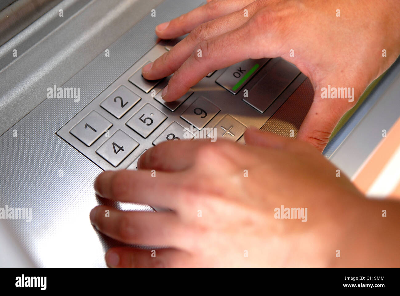 Woman inputting pin into atm machine Stock Photo - Alamy
