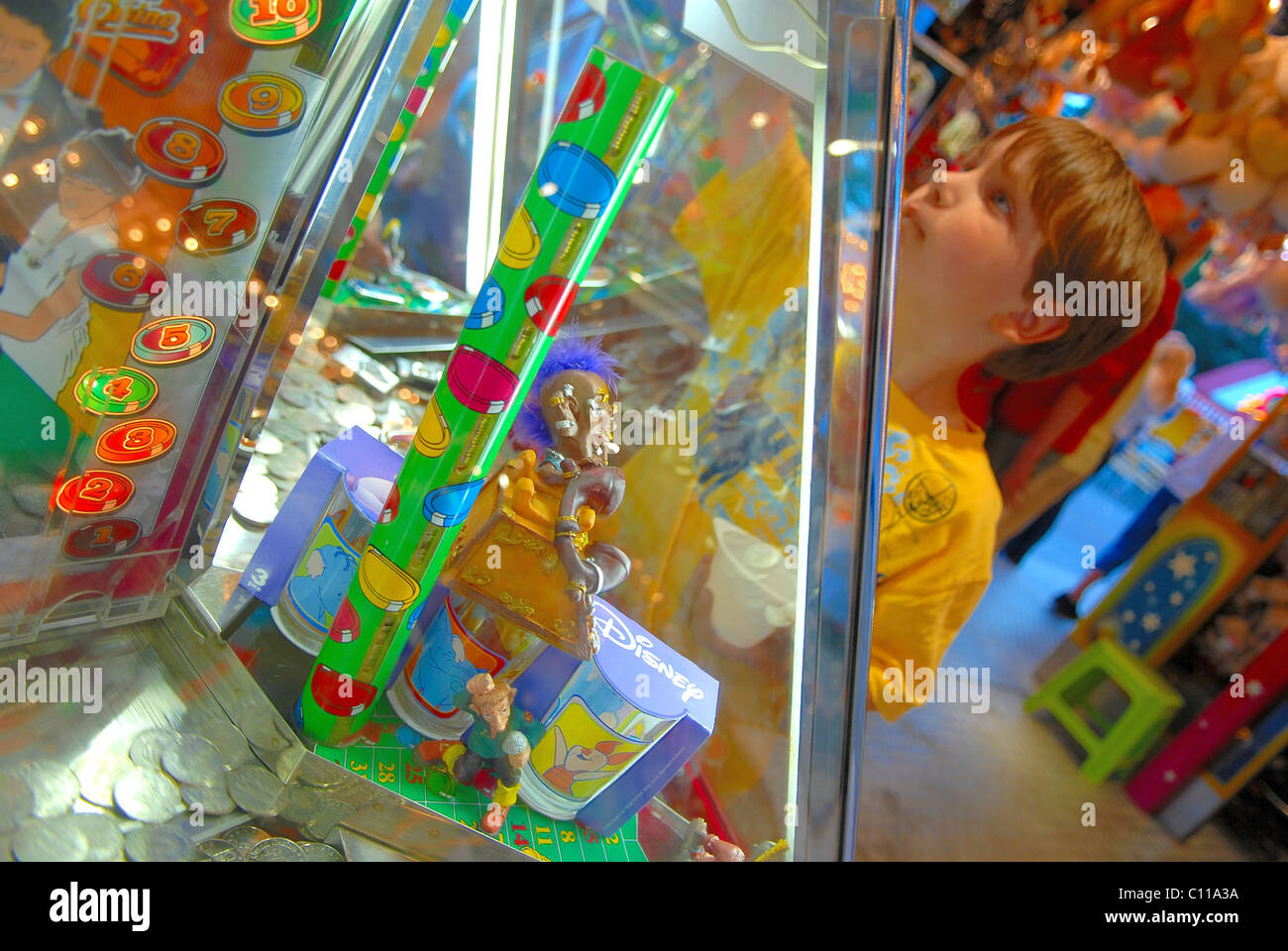 Boy playing on slot machine Stock Photo - Alamy