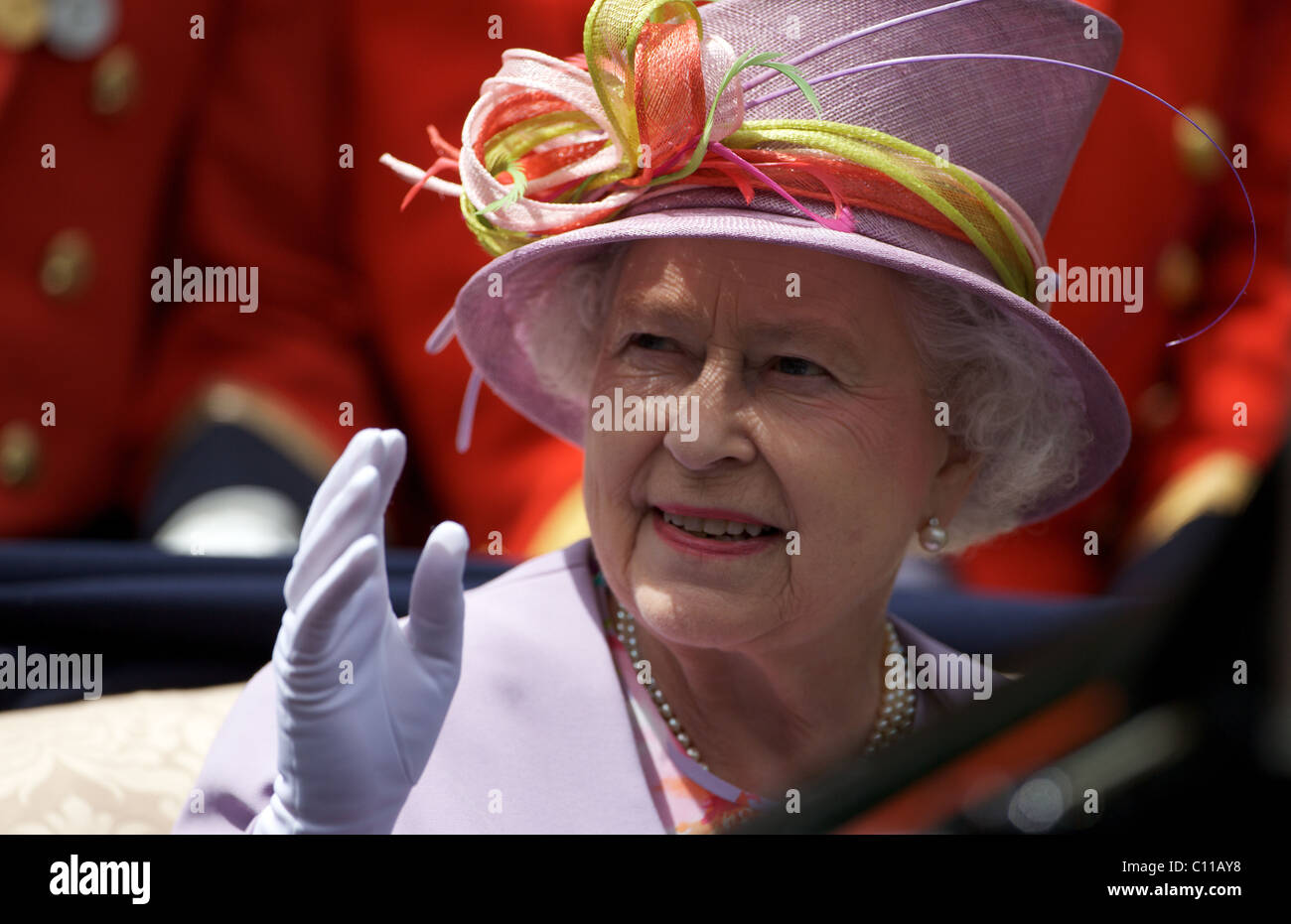 HRH Queen Elizabeth II waves to the public as she arrives at Royal ...