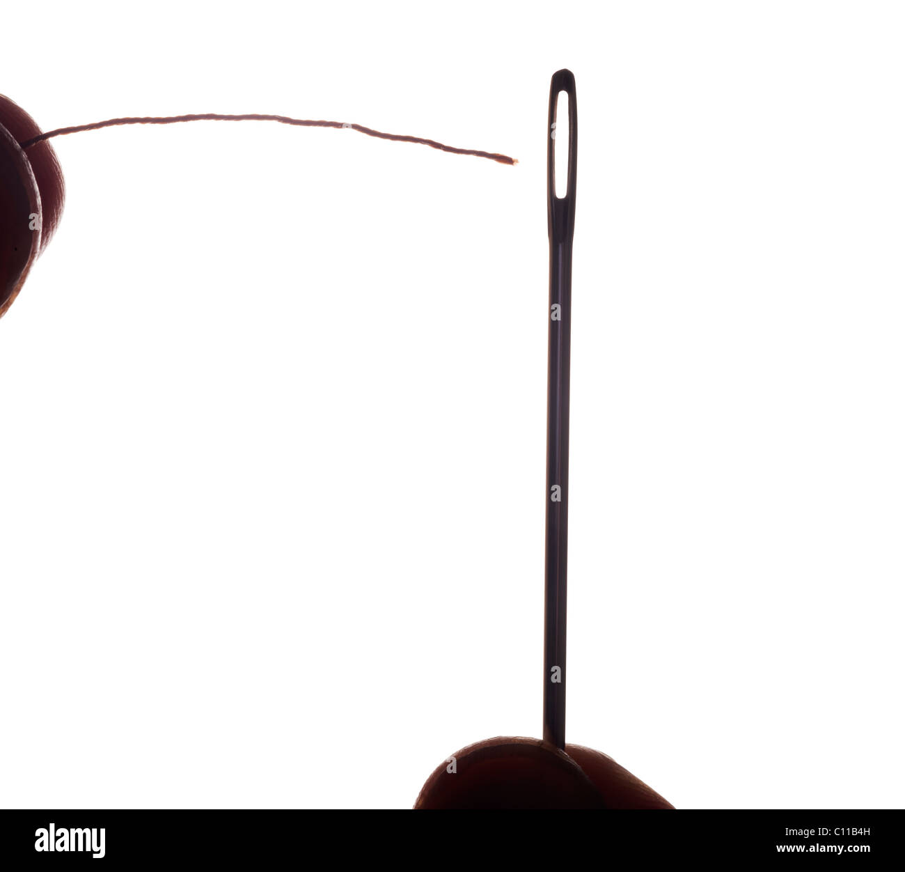 Fingers threading a Needle on a White Background Stock Photo - Alamy