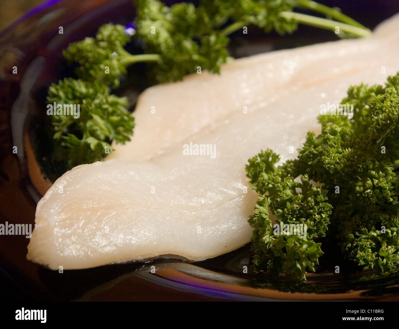 fillet of Haddock on blue plate Stock Photo - Alamy