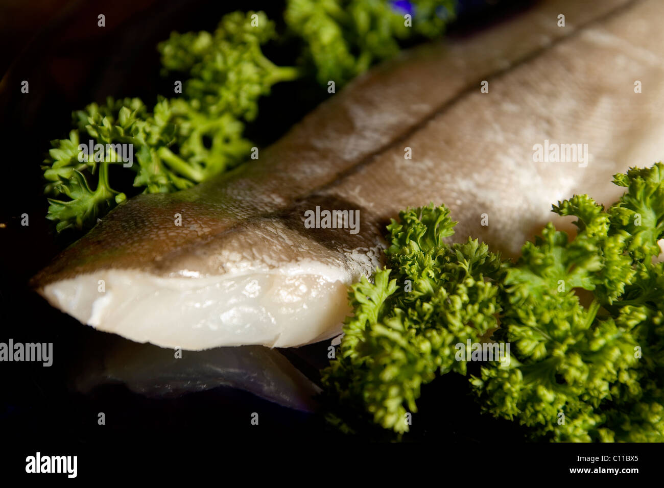 fillet of Haddock on blue plate Stock Photo - Alamy