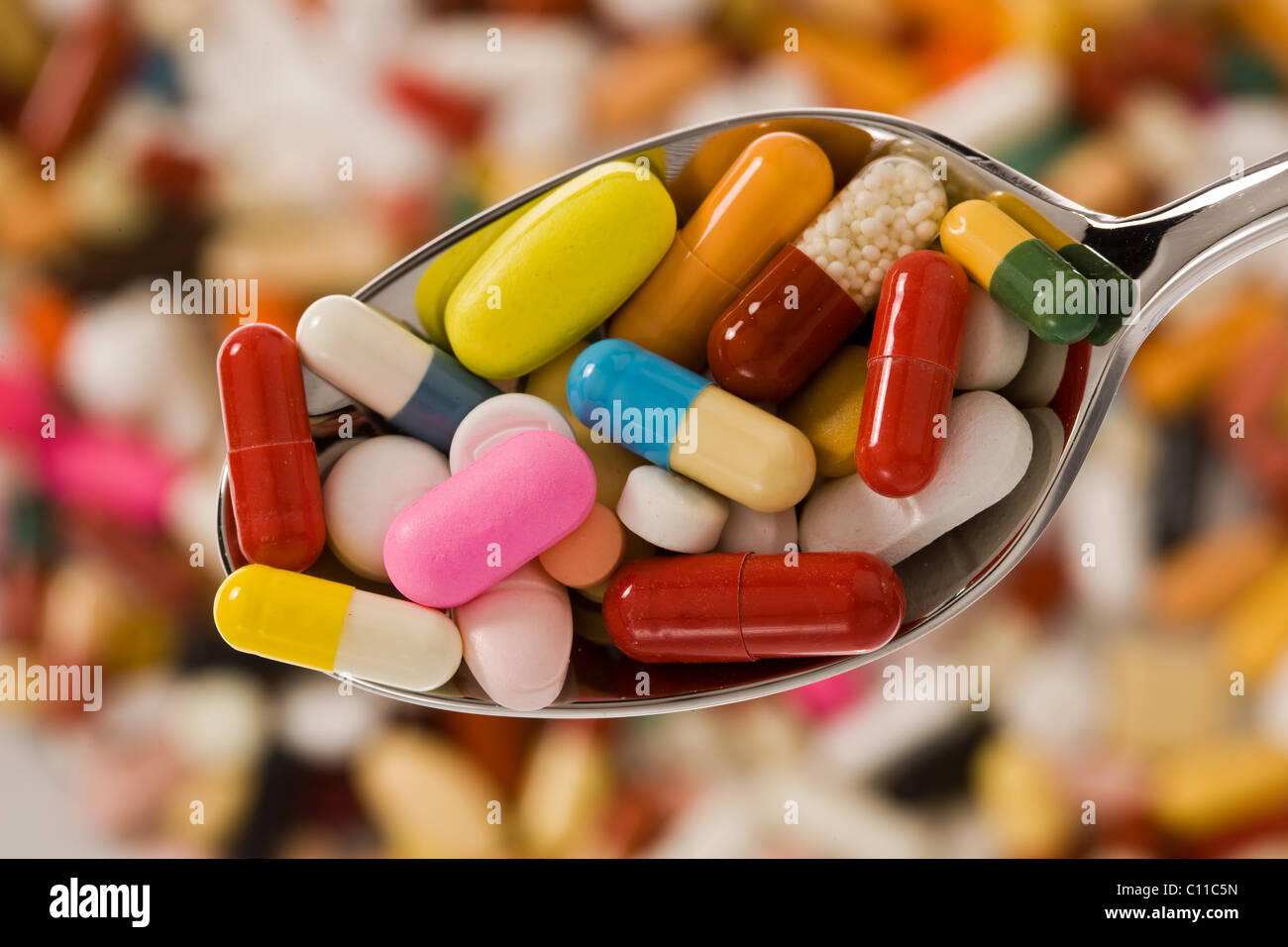 On a spoon lying tablets Stock Photo - Alamy