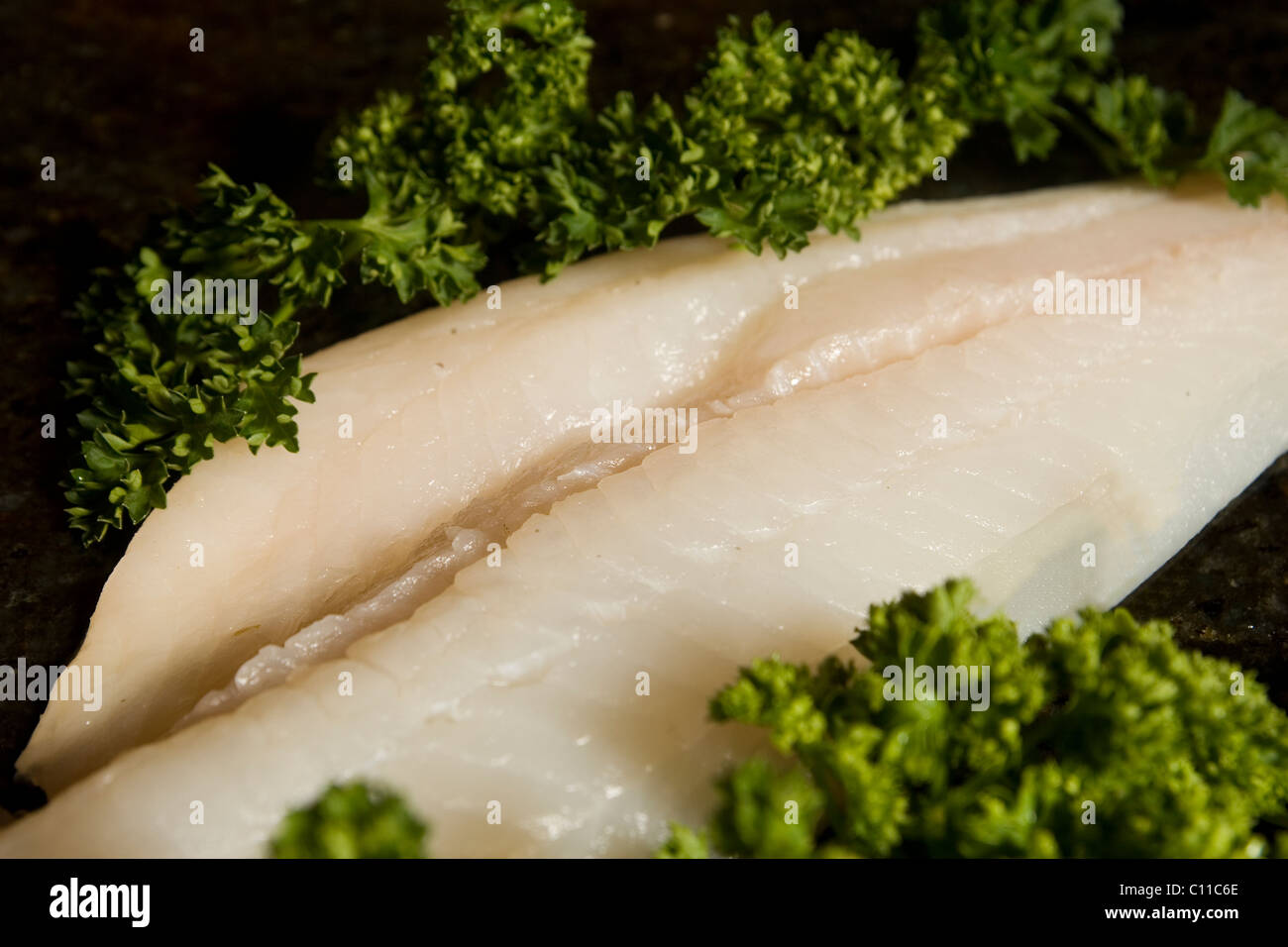 fillet of Haddock on blue plate Stock Photo - Alamy