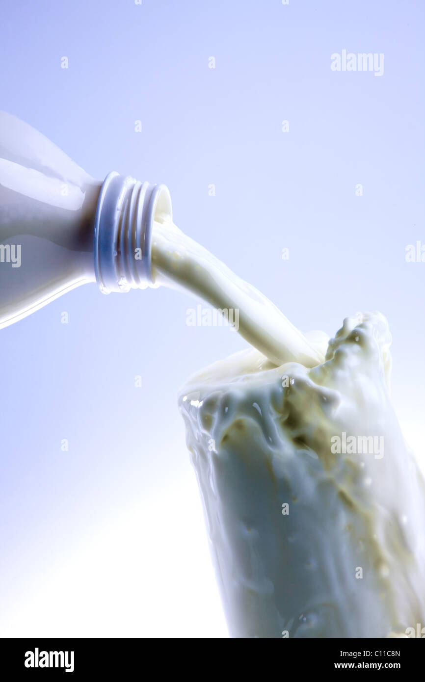 Fresh milk is poured into a glass Stock Photo - Alamy