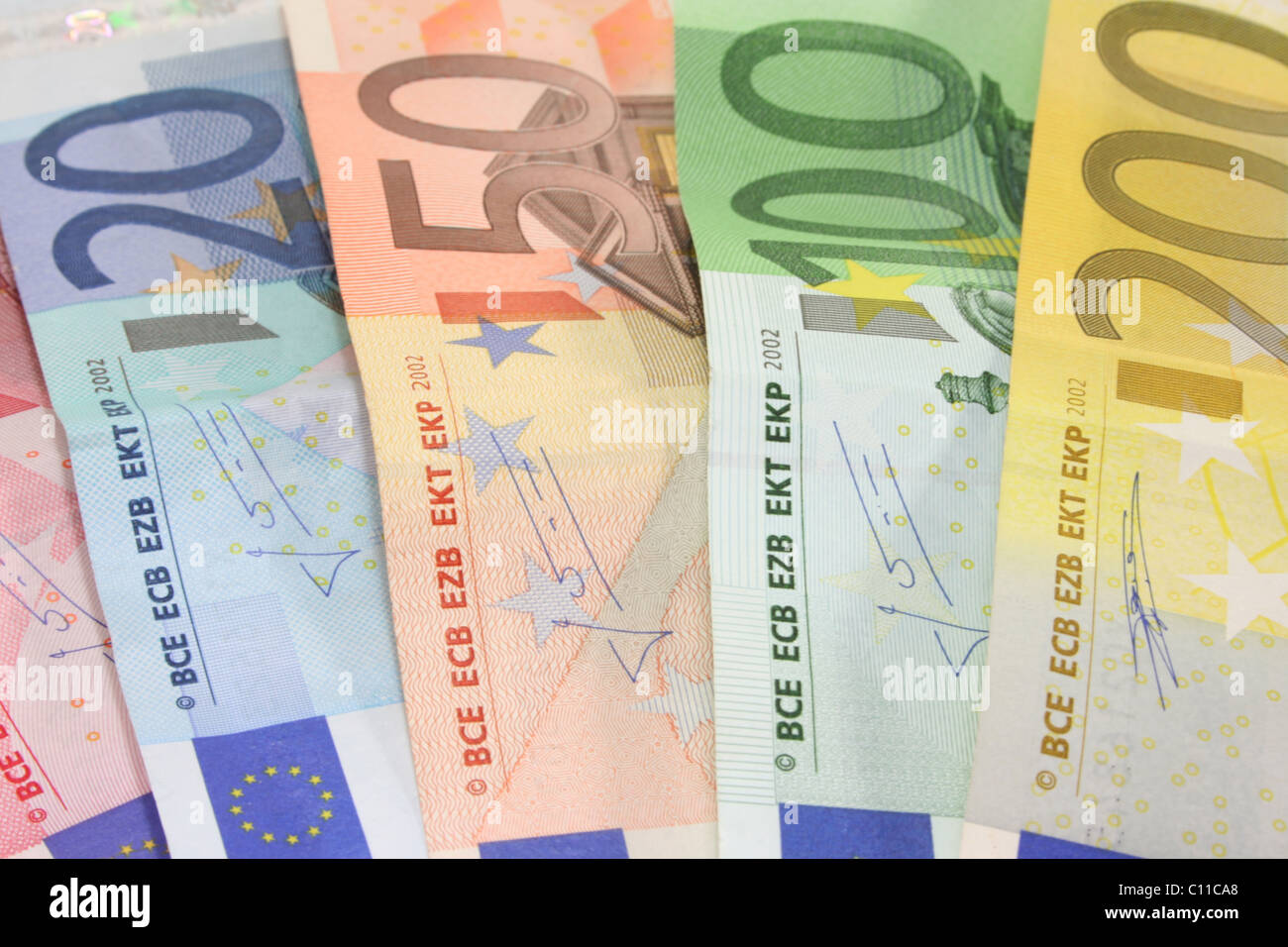 a big pile of euro notes on a white background Stock Photo - Alamy