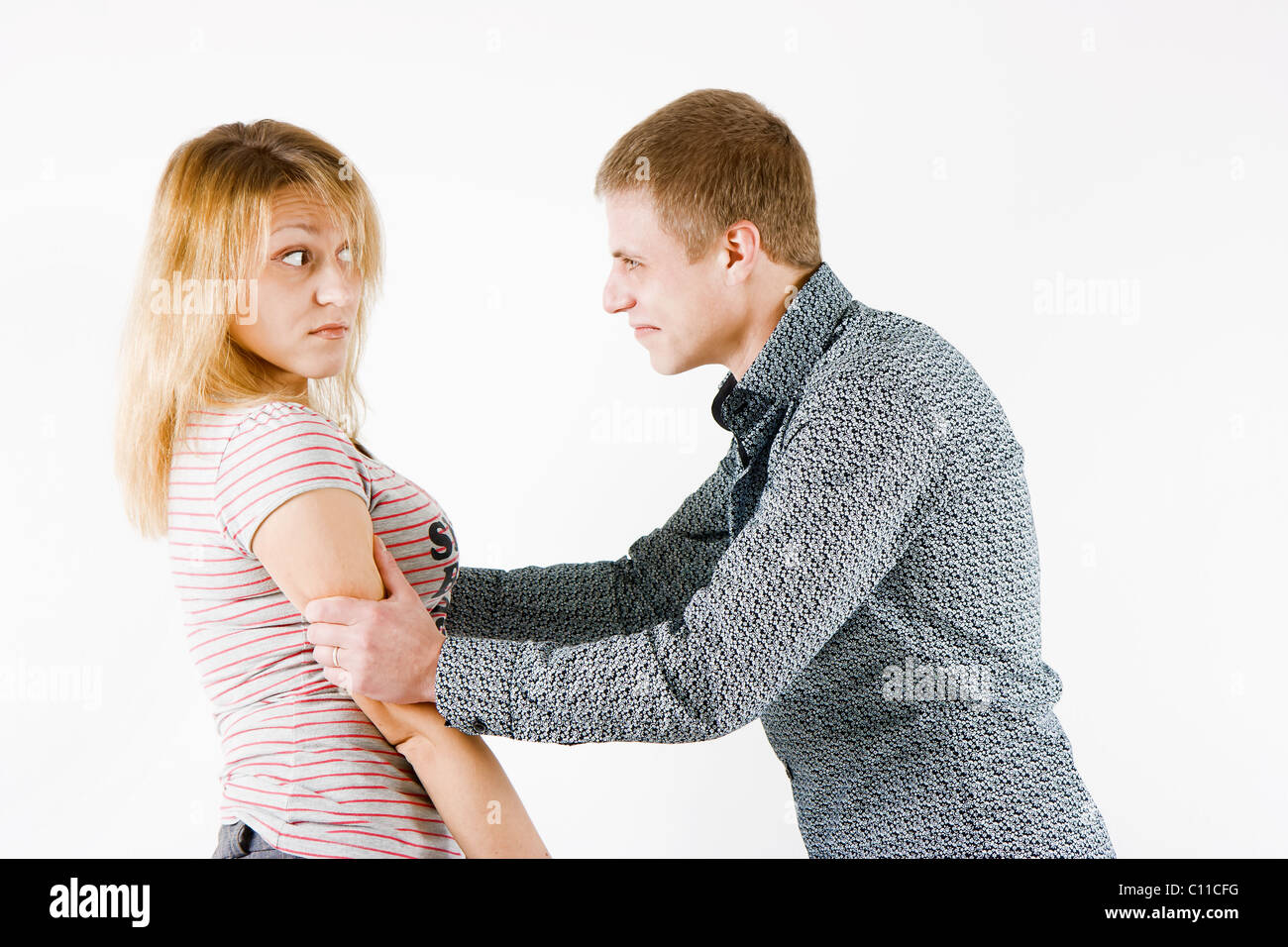 Man attacks woman on a white background Stock Photo - Alamy