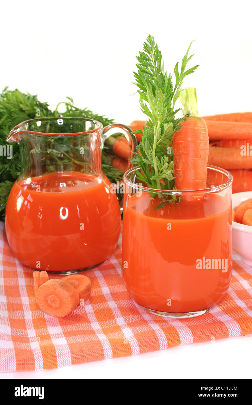 fresh carrot juice with a bunch of carrots and a carrot Stock Photo - Alamy
