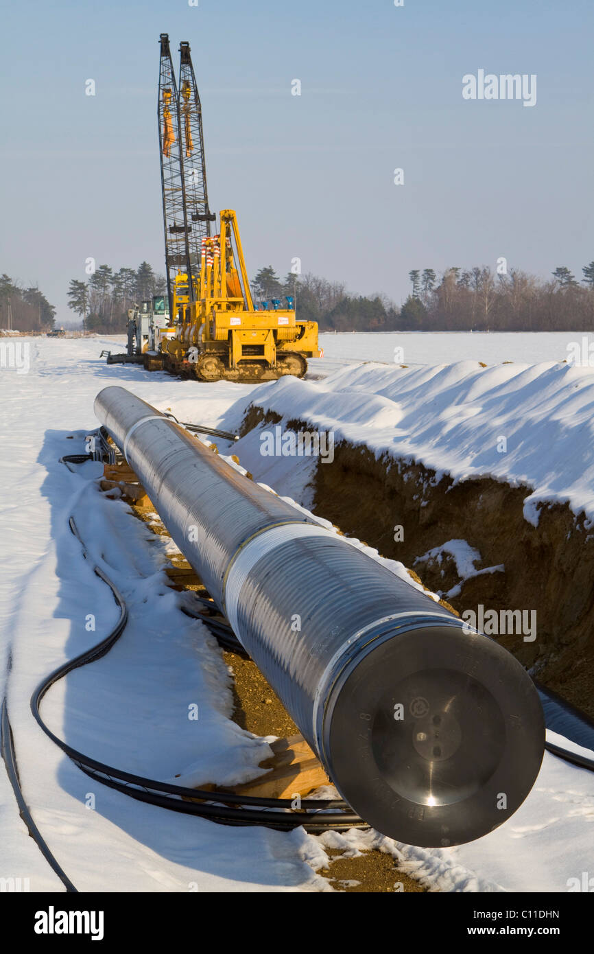 Pipes of a pipeline in front of tracked vehicles for laying a pipeline ...