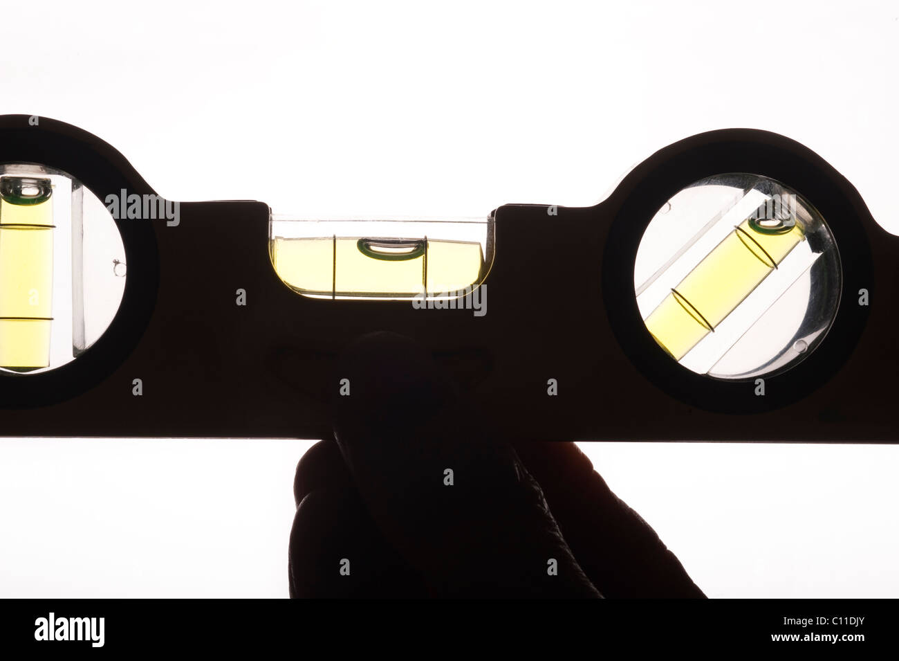 Hand holding a spirit level on a white background Stock Photo - Alamy
