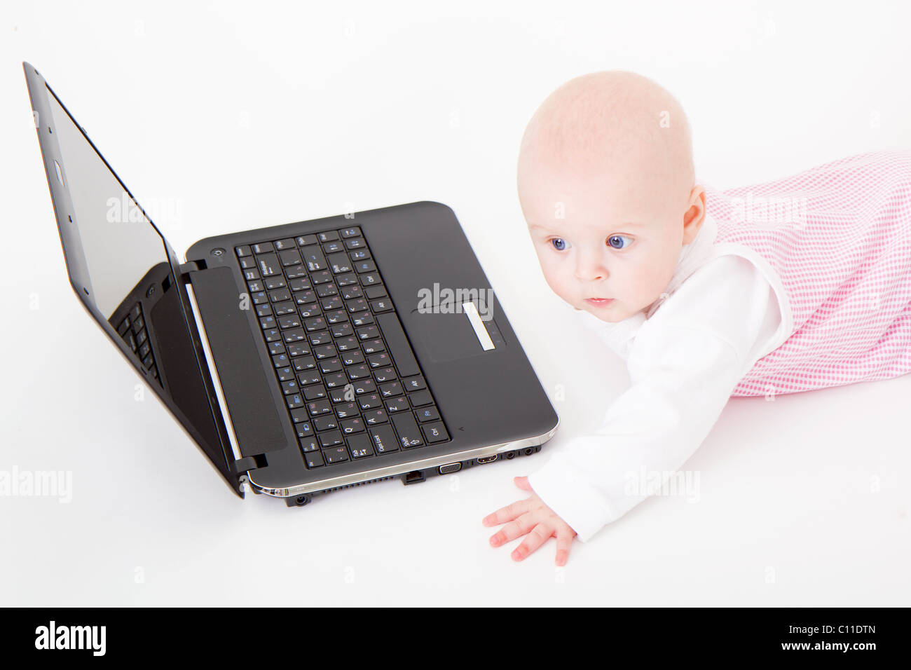 baby with laptop on a white background in studio Stock Photo - Alamy