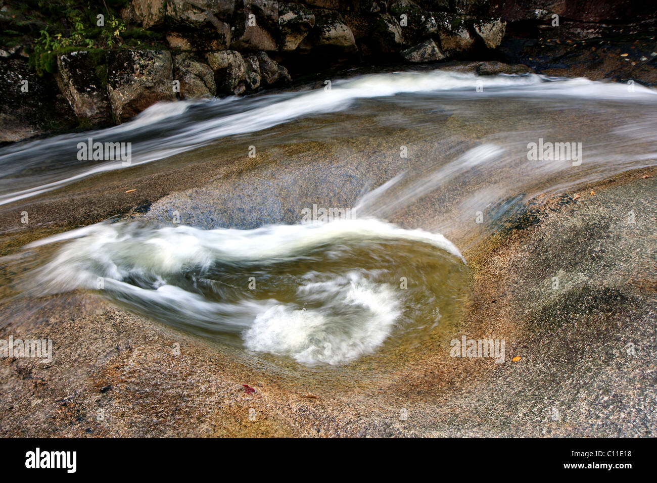 Waterfall water movement at fall time with stones and leaves Stock ...