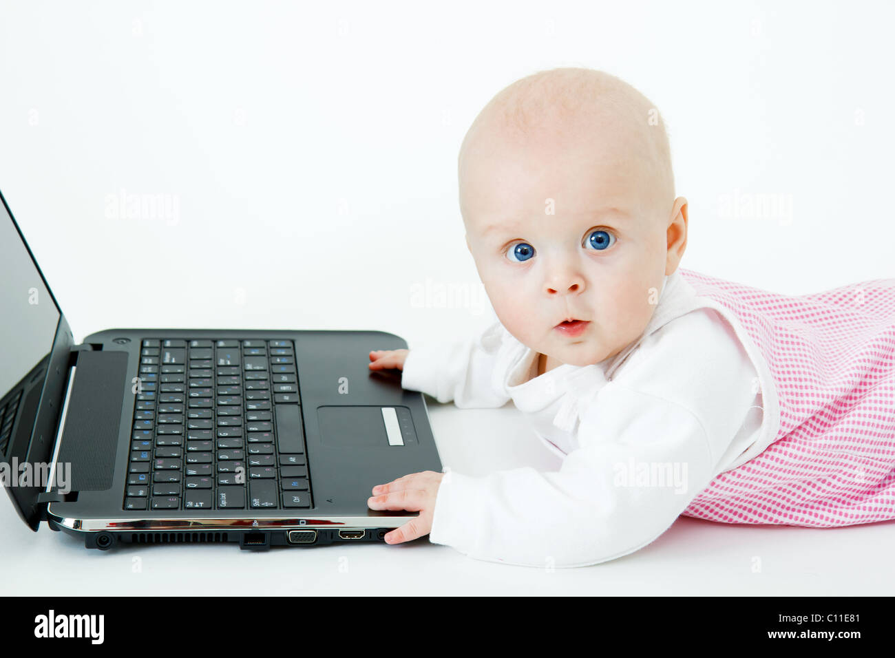 baby with laptop on a white background in studio Stock Photo - Alamy