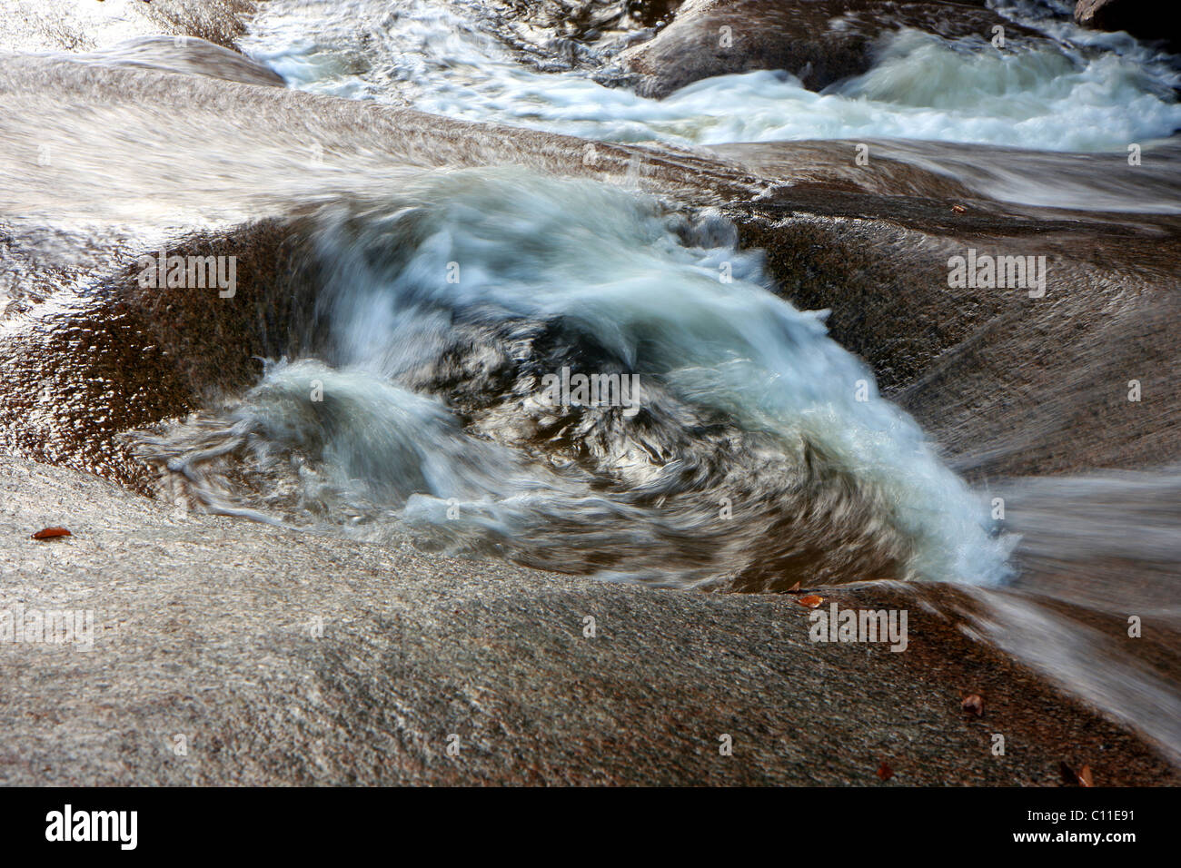 Waterfall water movement at fall time with stones and leaves Stock ...