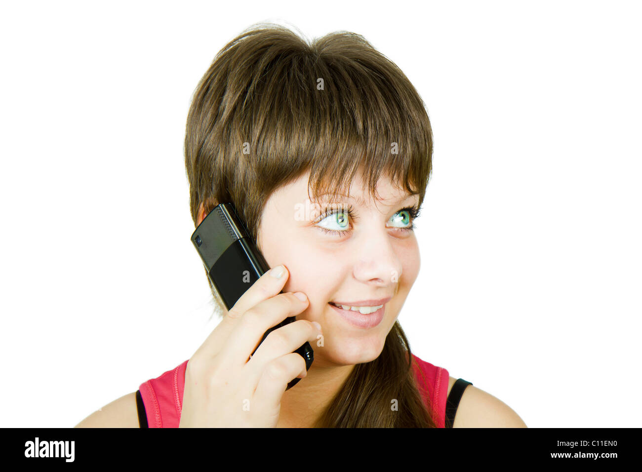 smiling beautiful girl with a phone on an isolated white background ...