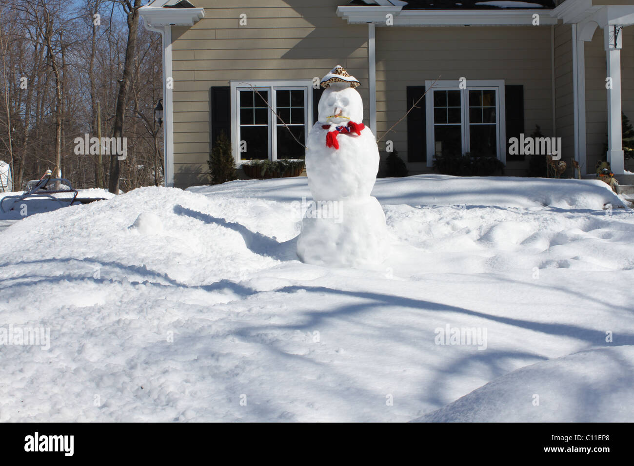 Snowman in front of a house Stock Photo - Alamy