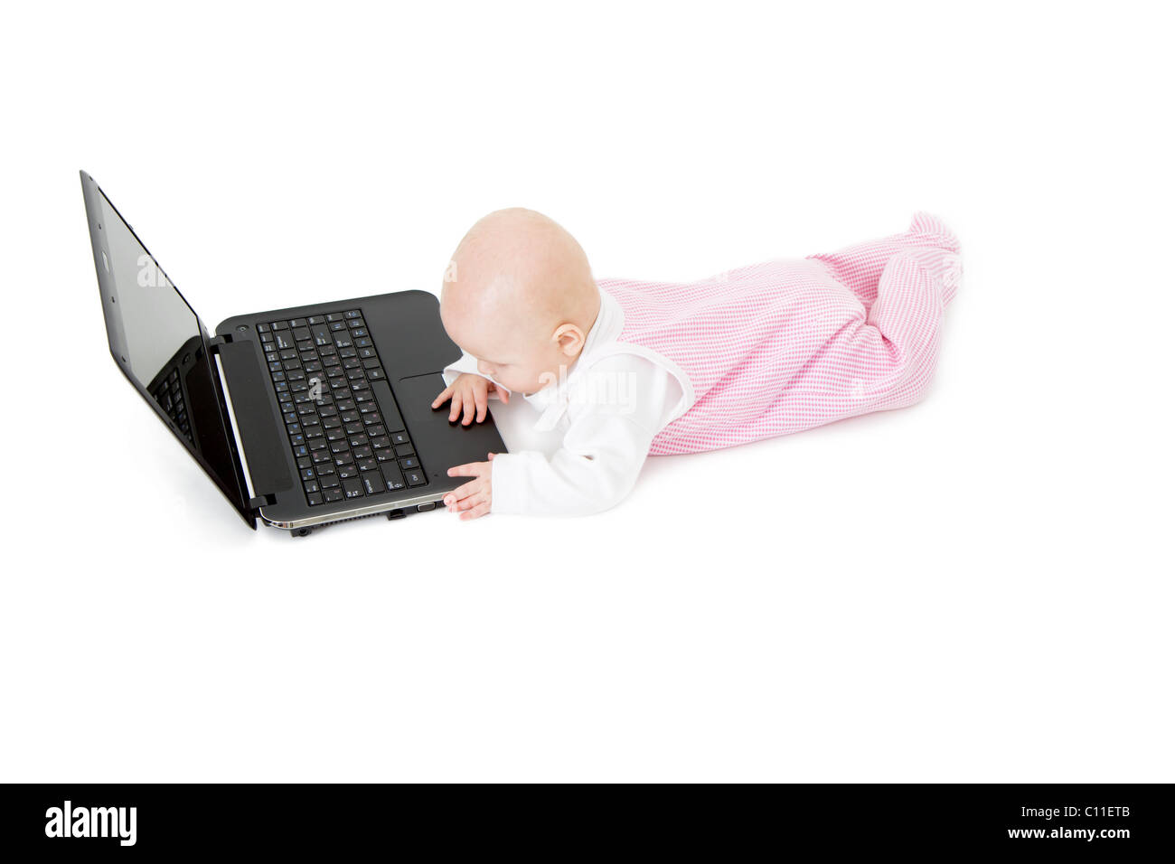 baby with laptop lying on a white background Stock Photo - Alamy