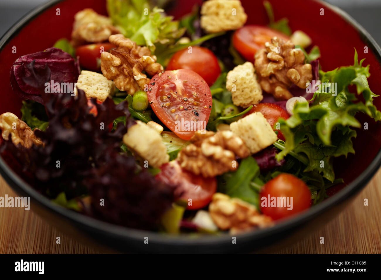 A healthy leafy salad with tomatoes, nuts, onions and croutons Stock ...