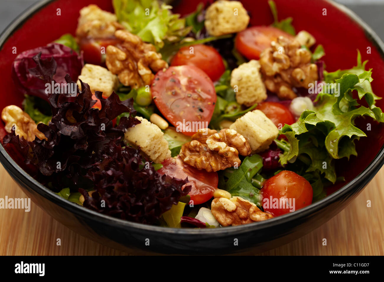 A healthy leafy salad with tomatoes, nuts, onions and croutons Stock ...