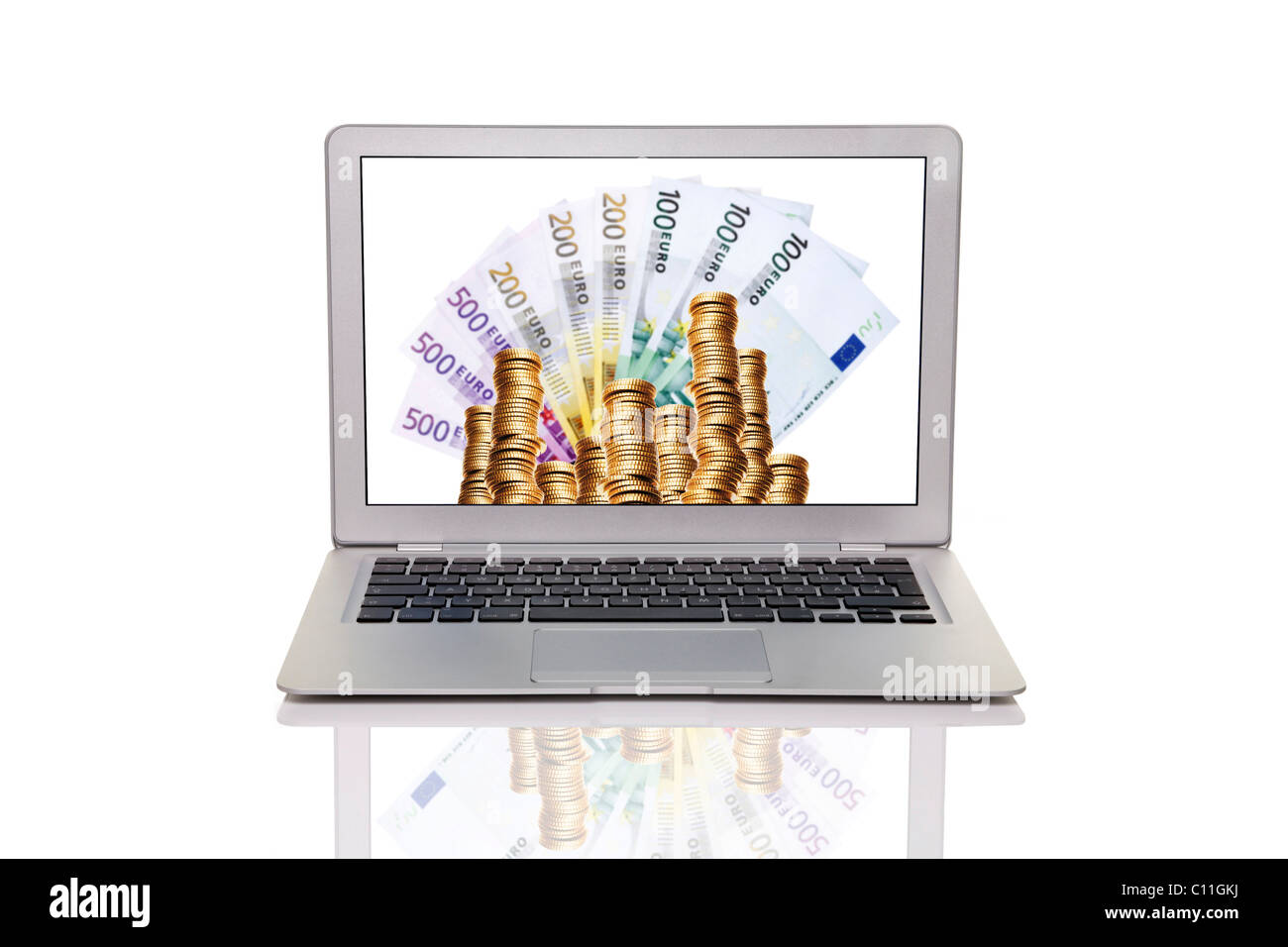 Laptop with money Stock Photo - Alamy