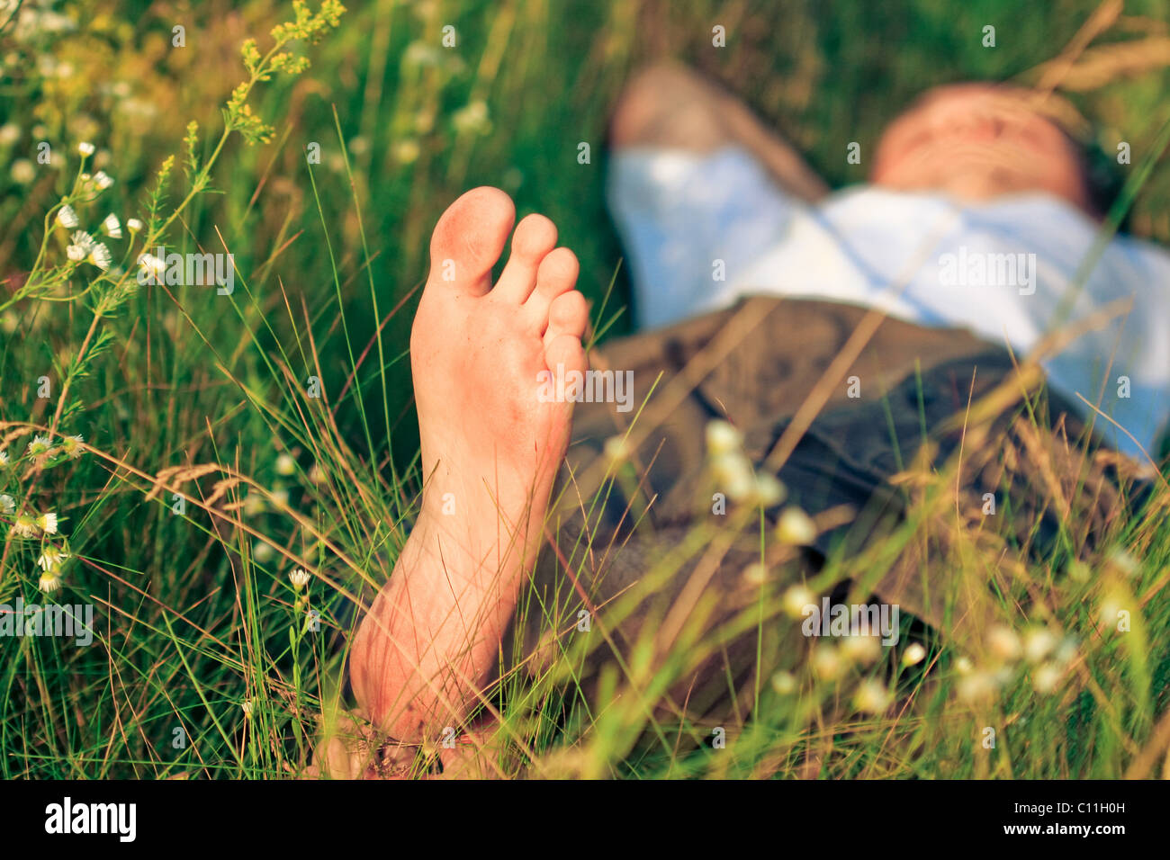 young adult man in spring grass Stock Photo - Alamy
